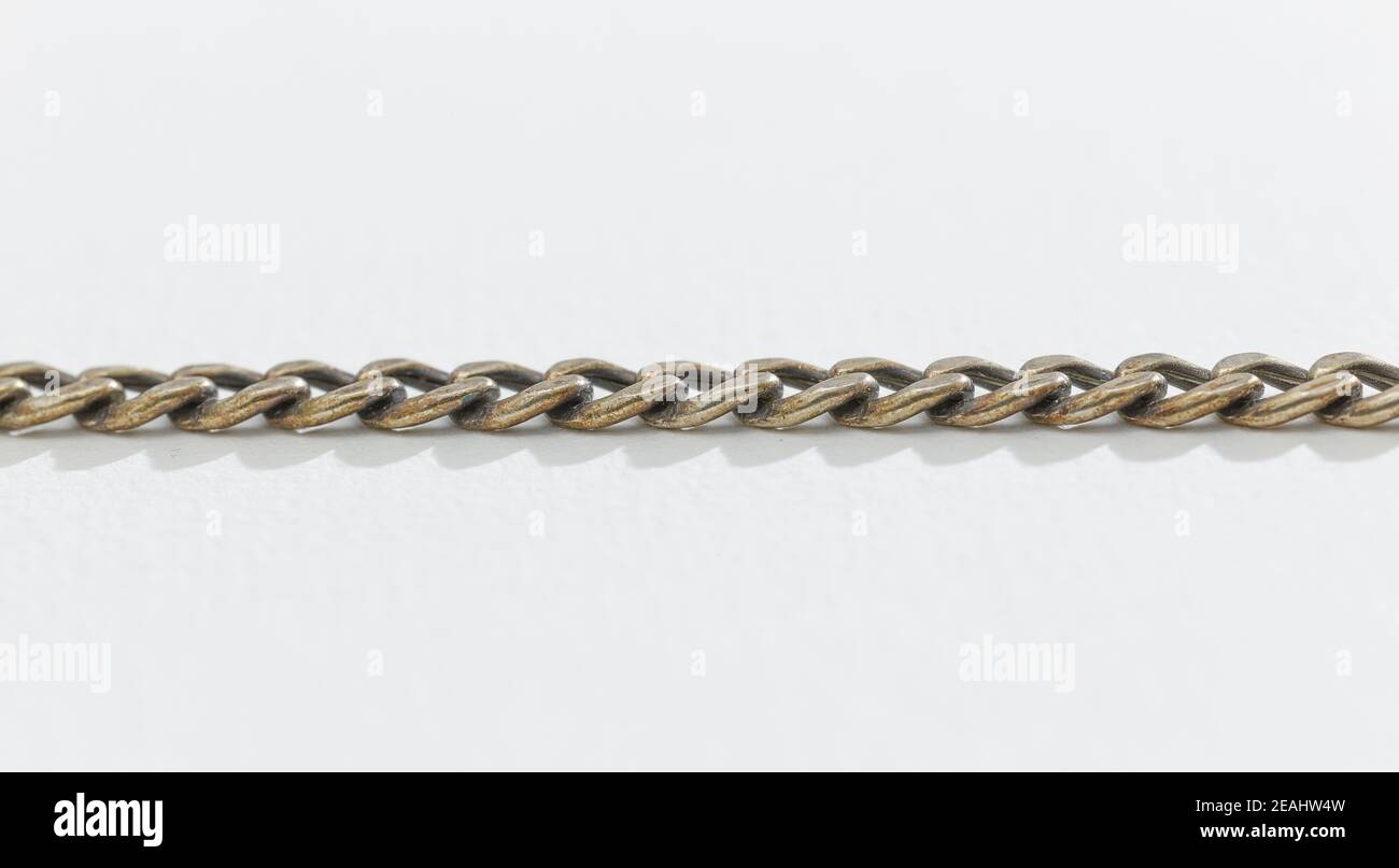 old silver chain on white paper background Stock Photo - Alamy
