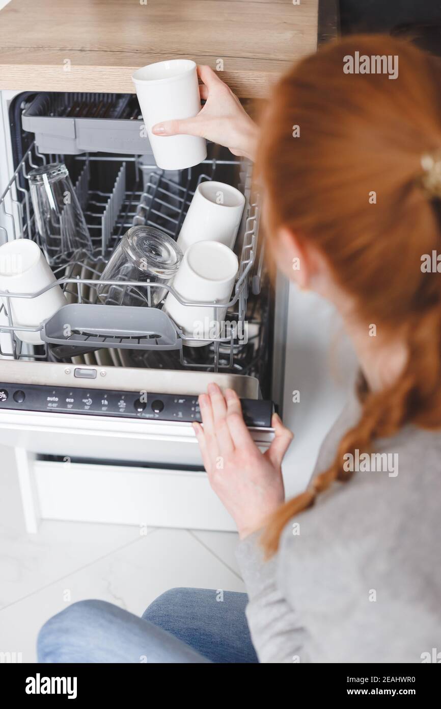 Young Girl by the Dishwasher with a plate Stock Photo - Alamy