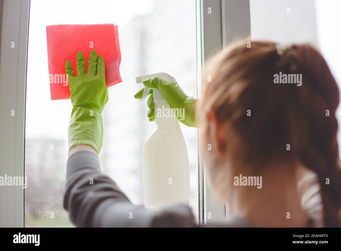 Women cleaning a window with spray and cloth. Close up Stock Photo - Alamy