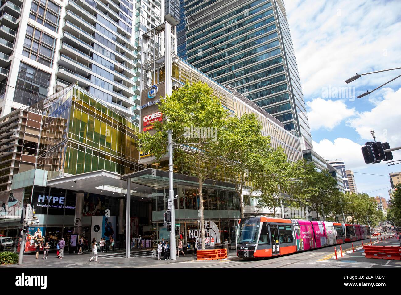 World Square in Sydney city centre with light rail train travelling ...