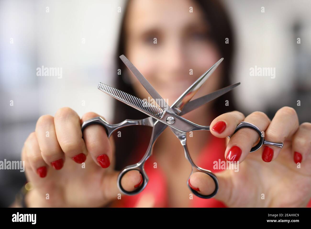 Hairdresser holds working scissors with comb in his hands Stock Photo ...