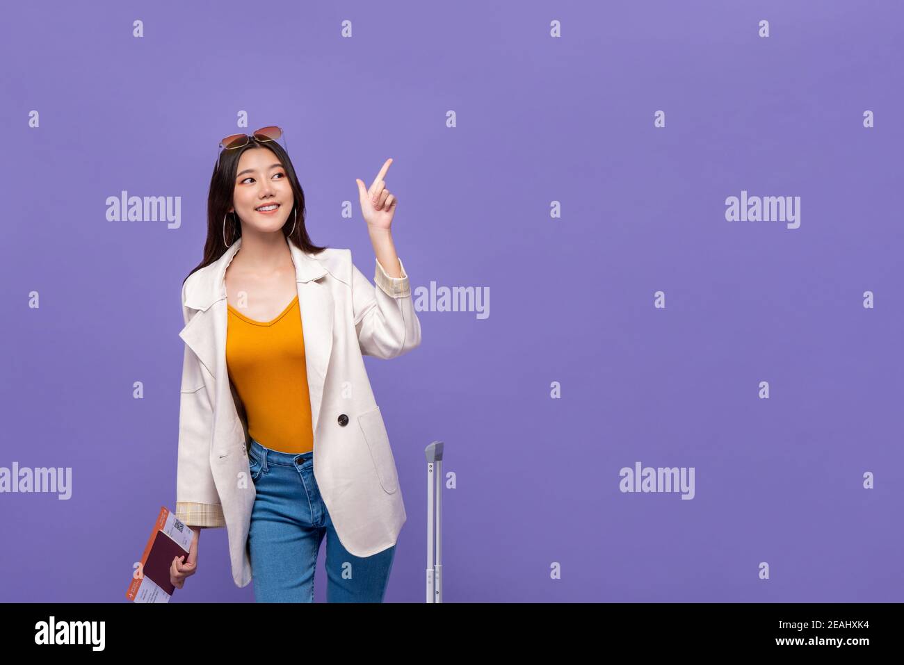 Beautiful smiling young Asian woman tourist holding passport and ...