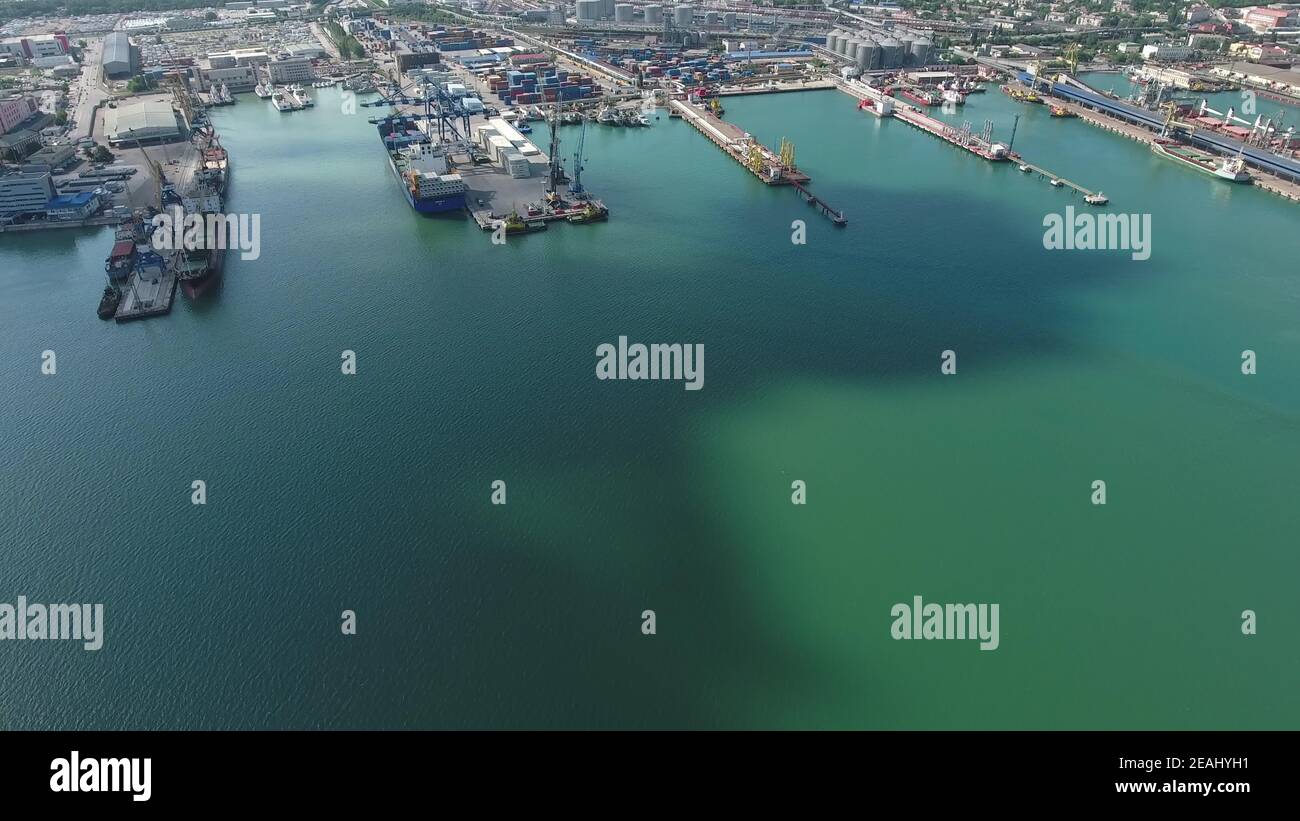 Industrial seaport, top view. Port cranes and cargo ships and barges ...