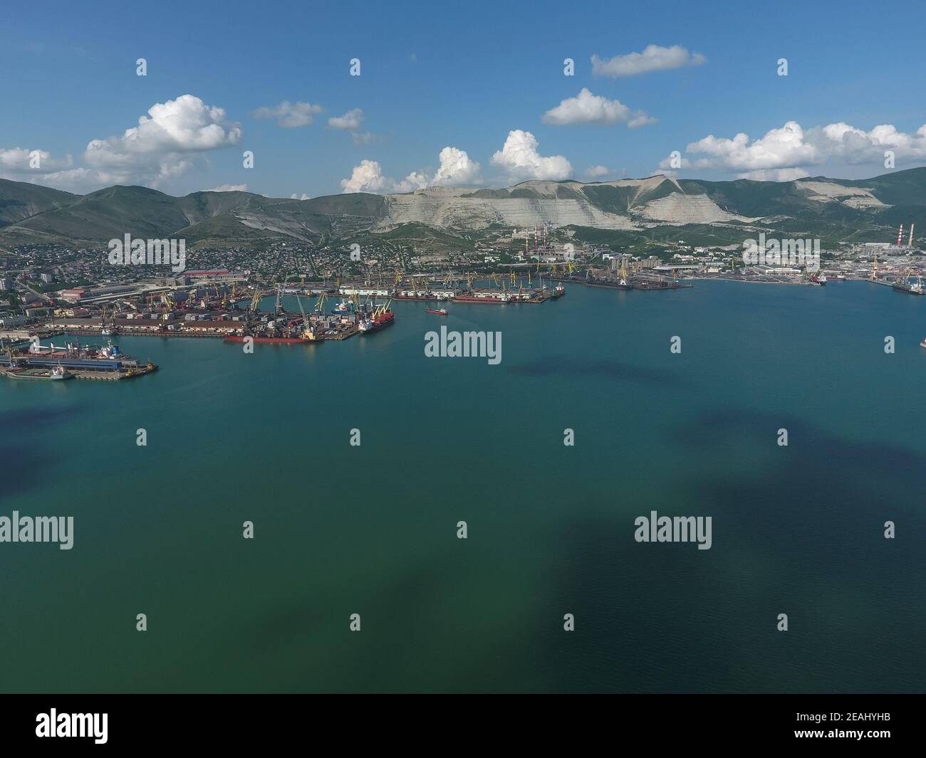 Industrial seaport, top view. Port cranes and cargo ships and barges ...