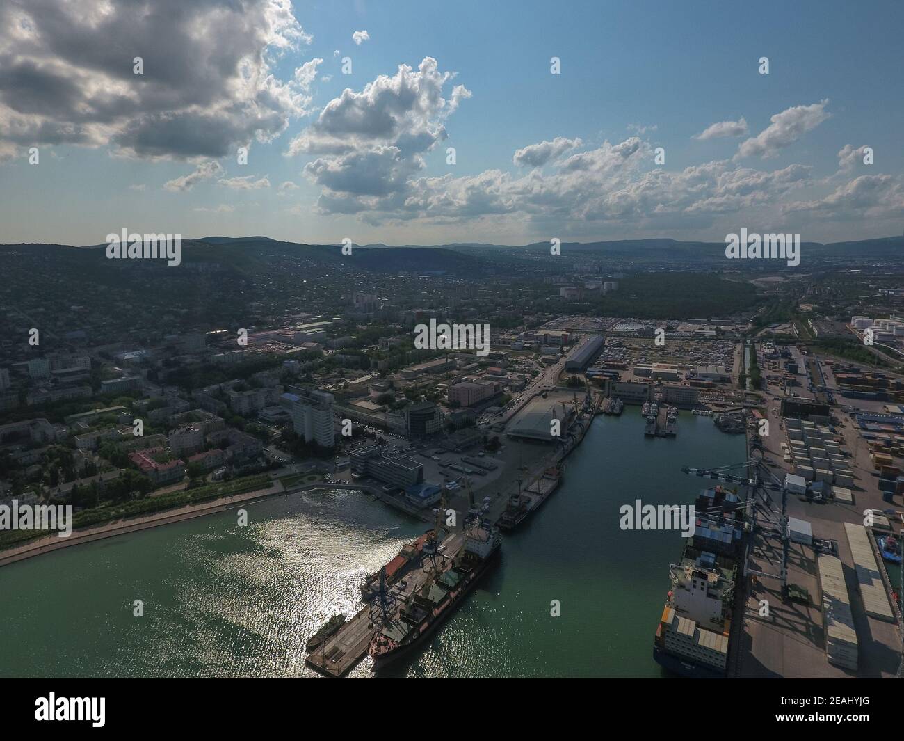 Industrial seaport, top view. Port cranes and cargo ships and barges ...