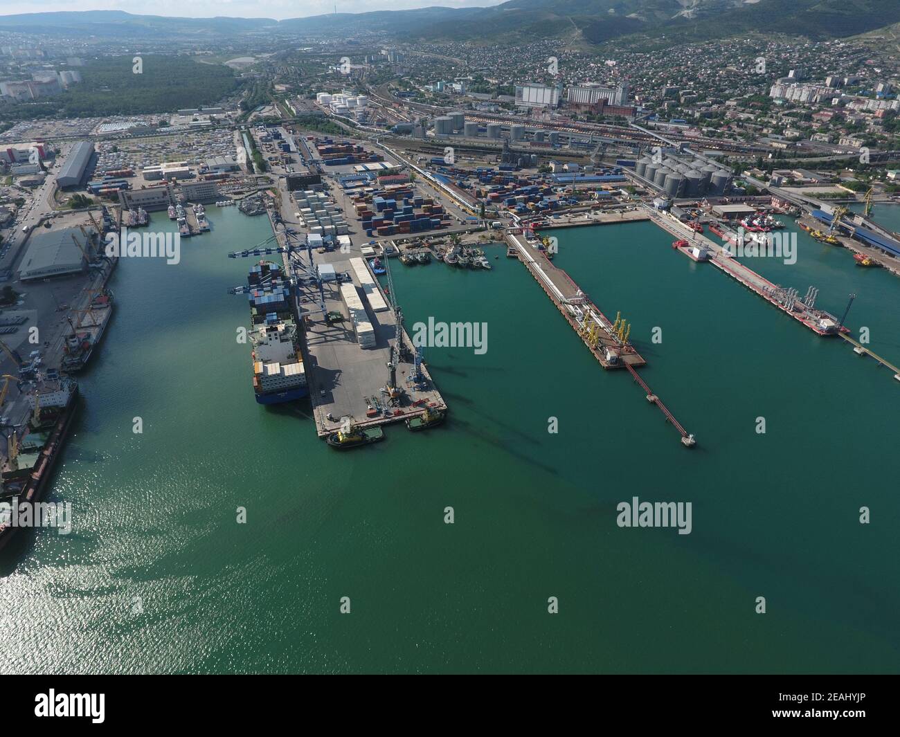 Industrial seaport, top view. Port cranes and cargo ships and barges ...
