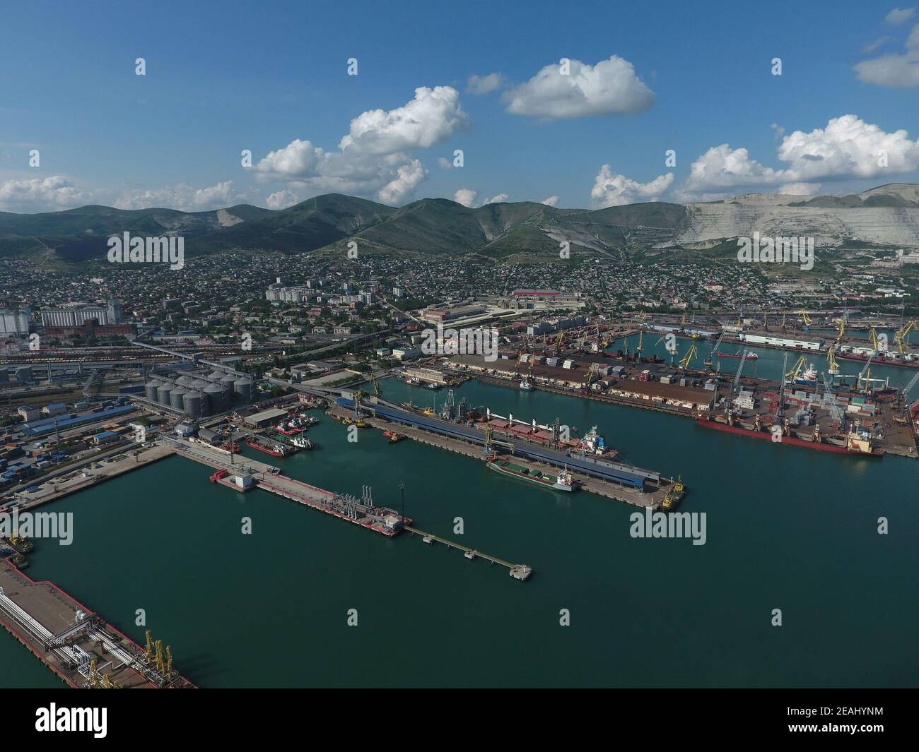 Industrial seaport, top view. Port cranes and cargo ships and barges ...