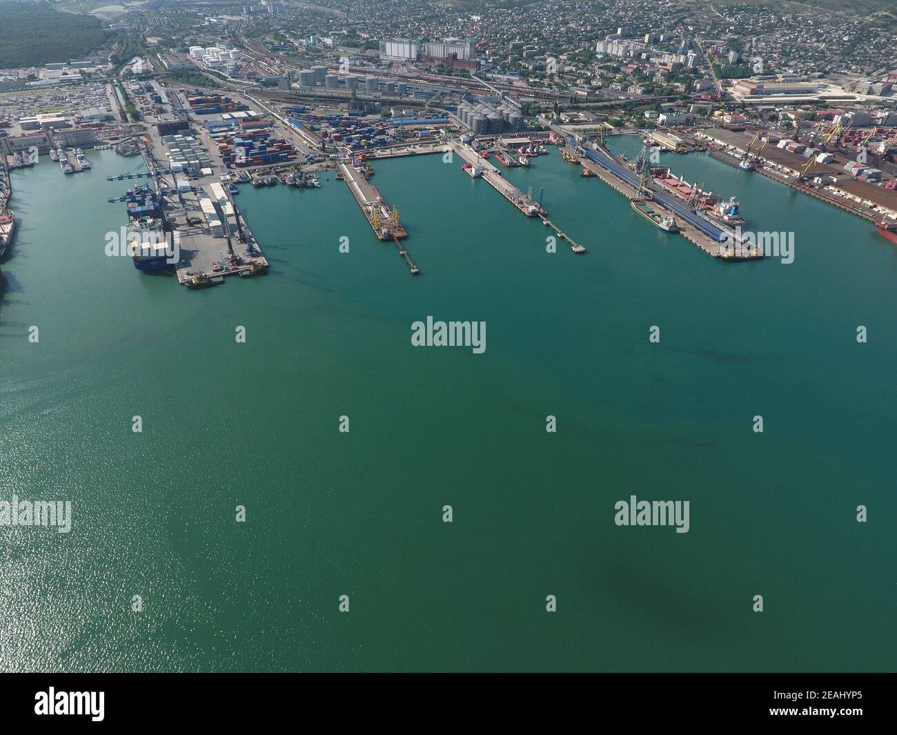 Industrial seaport, top view. Port cranes and cargo ships and barges ...