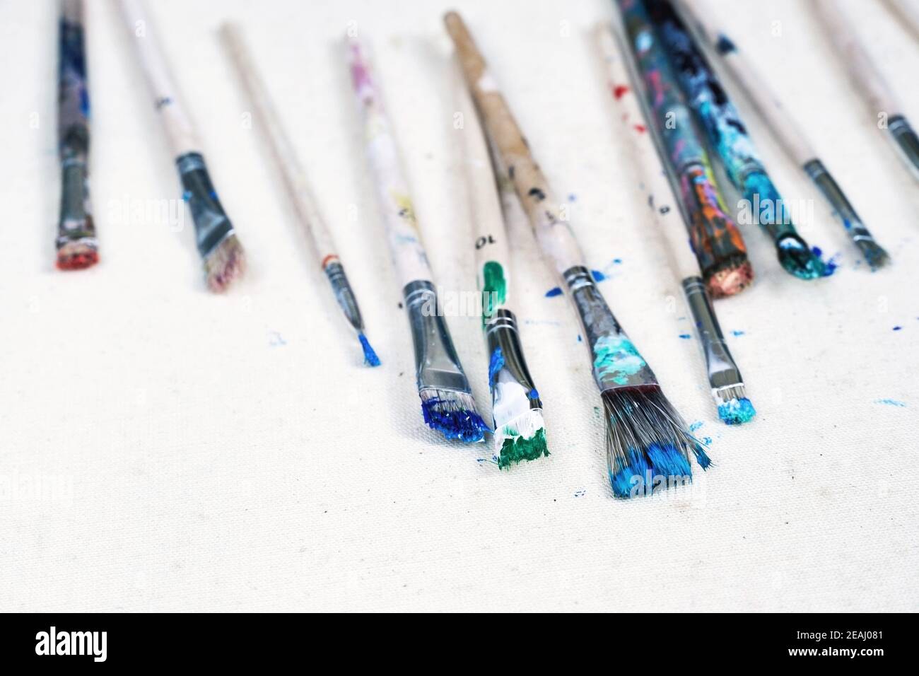 Artist paint brushes on canvas Stock Photo - Alamy