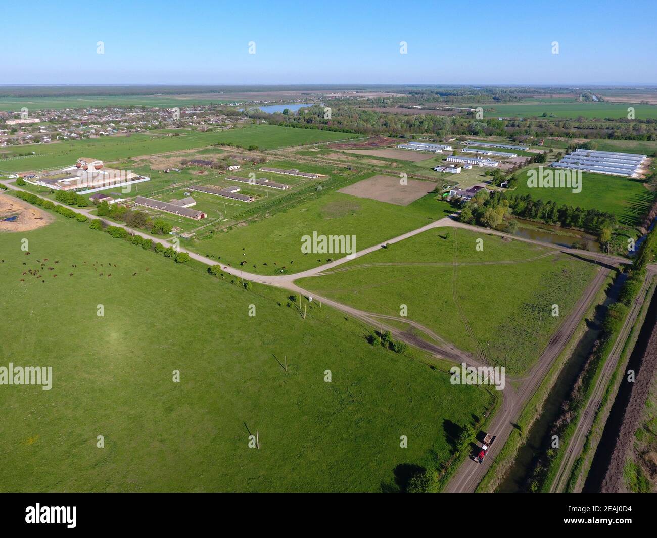 Rural landscape. View from above. On the horizon there is a poultry ...