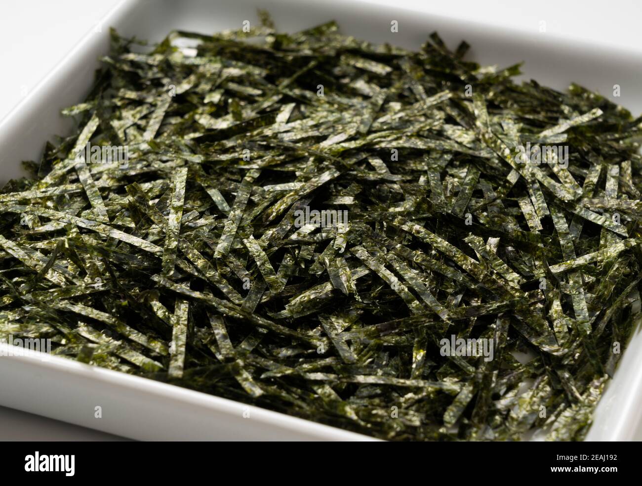 Chopped seaweed on a white background Stock Photo - Alamy