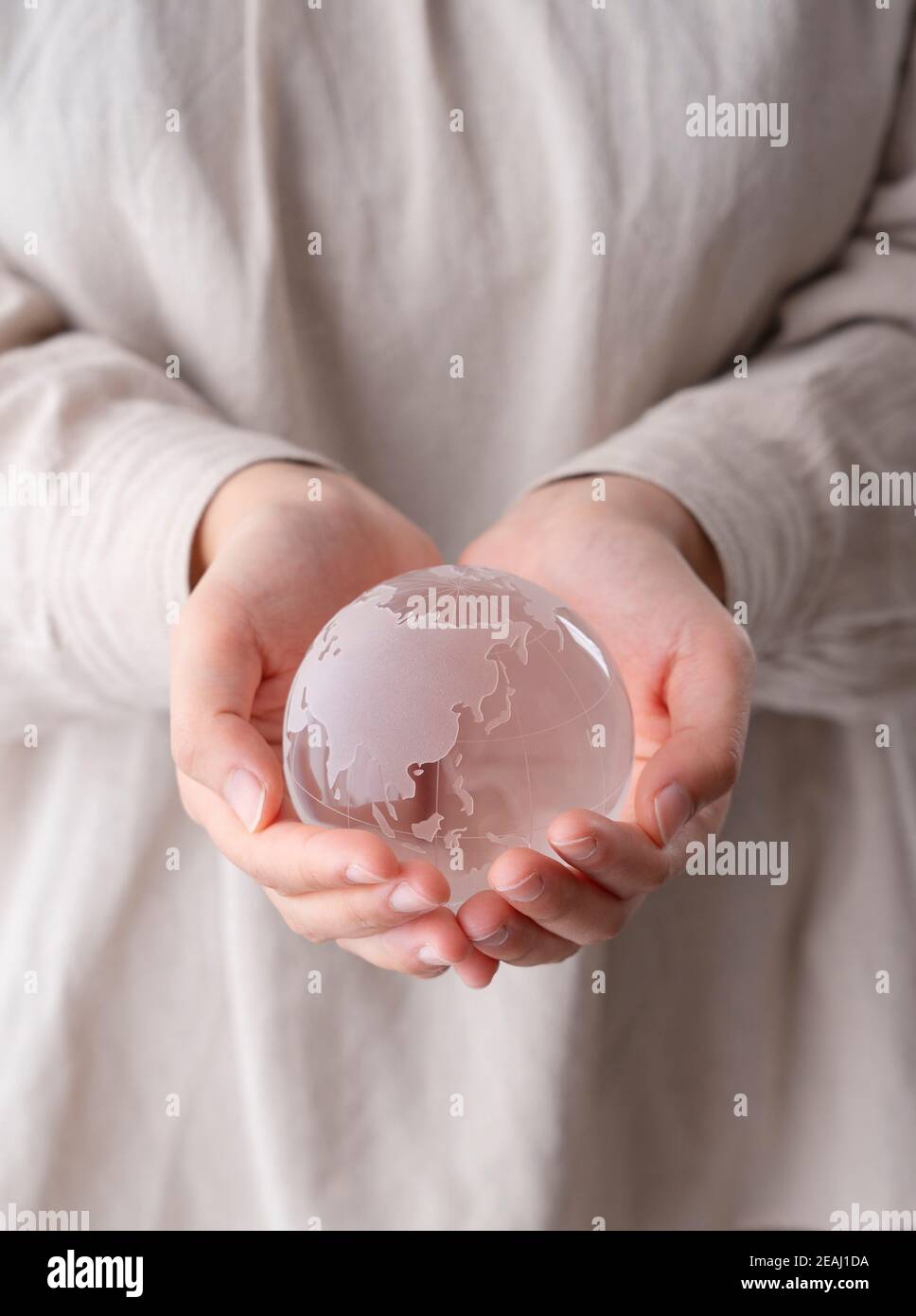 Female hand with glass globe. Peace and ecology Stock Photo - Alamy