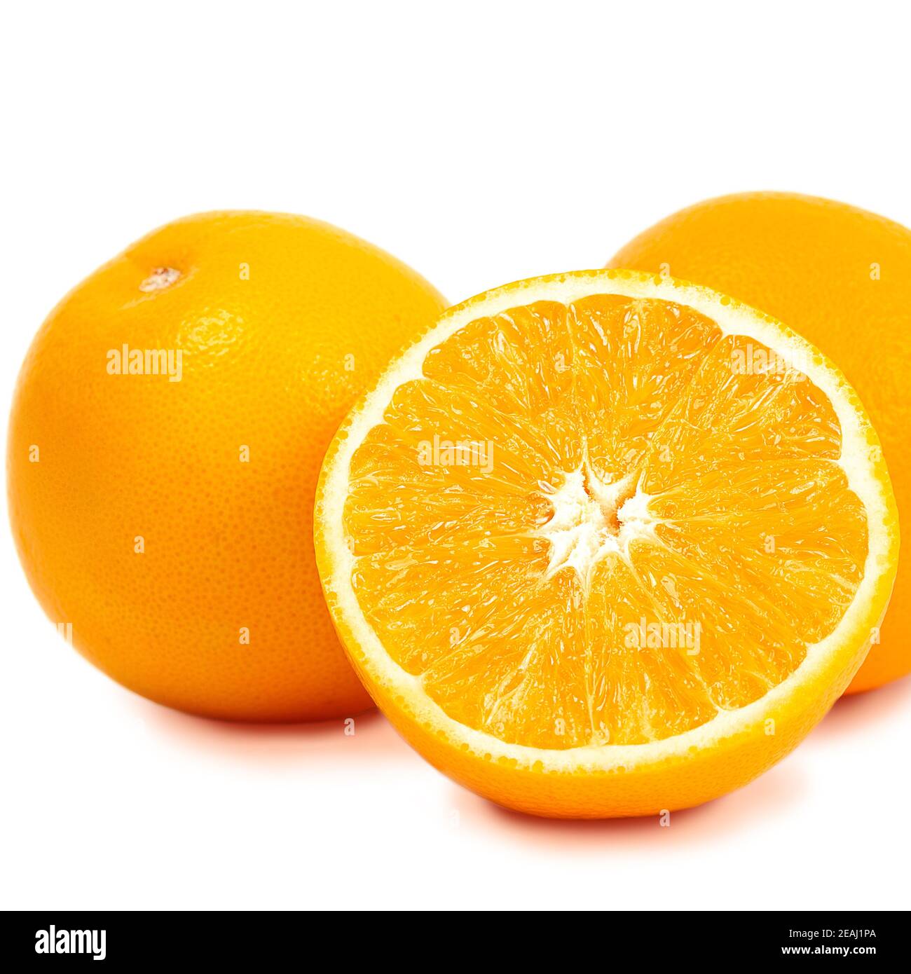 Two whole oranges and half an orange isolated on a white background ...