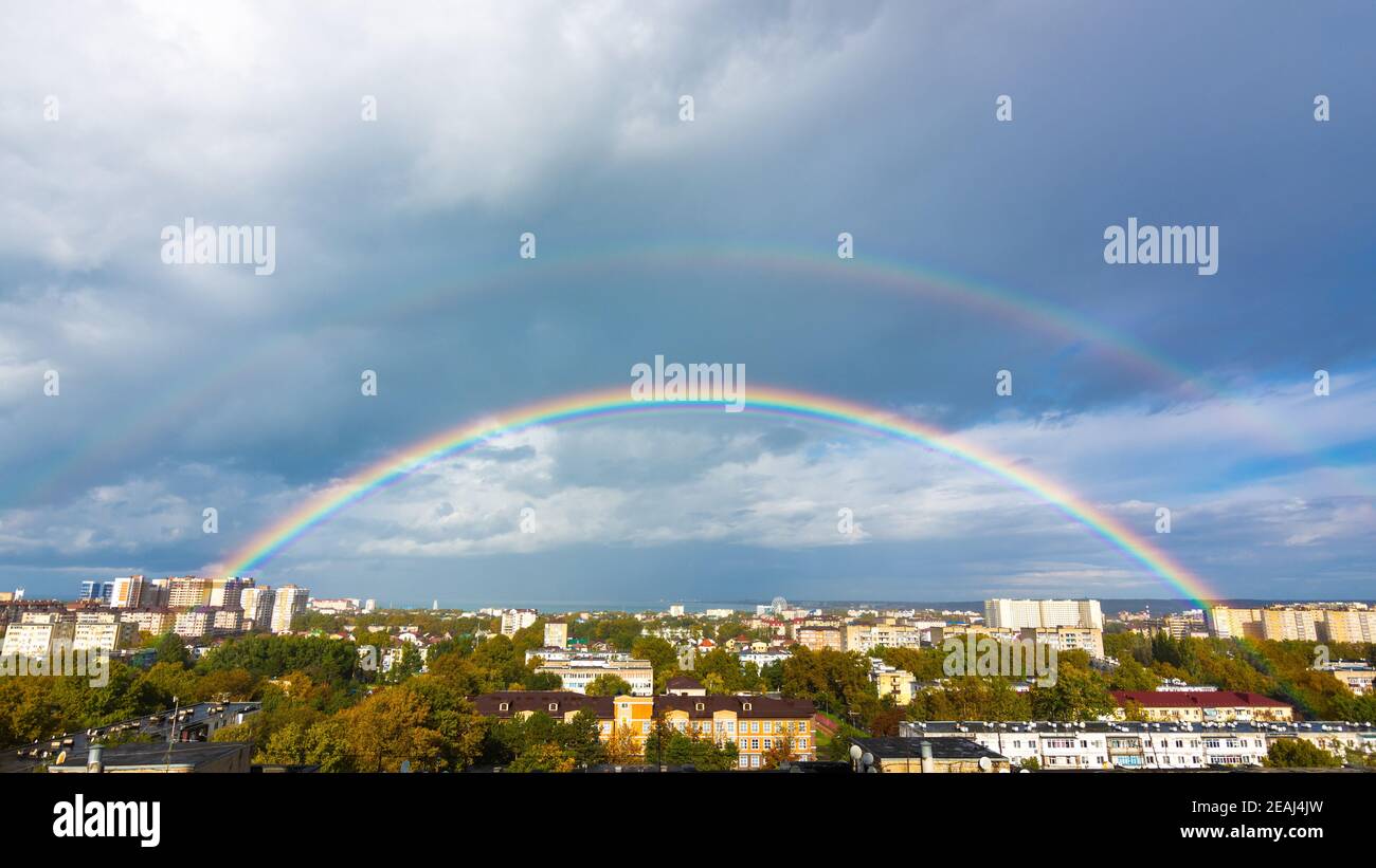 Double rainbow in the sky over the roofs of the resort city of Anapa ...