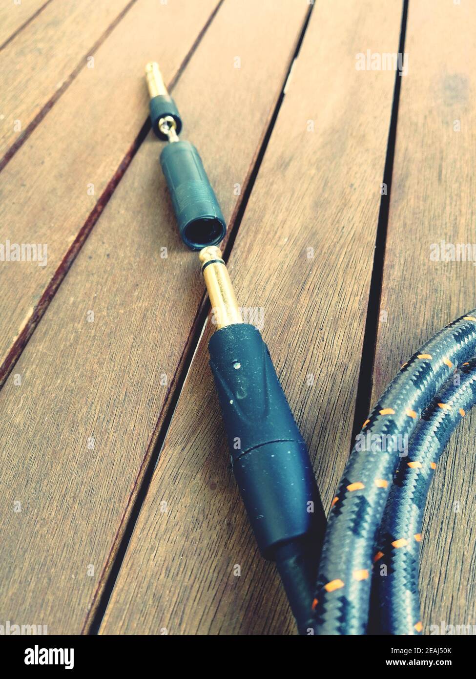 guitar cable jack connector wood table 2 Stock Photo - Alamy