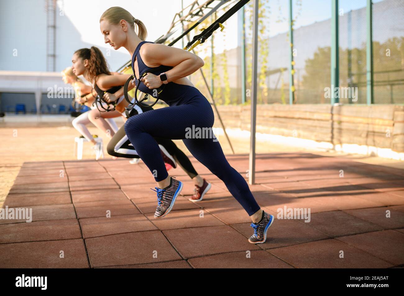 Women doing exercise outdoors, group training Stock Photo - Alamy