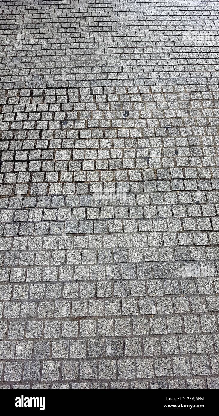 Vertical high angle shot of street pavers captured during the daytime ...