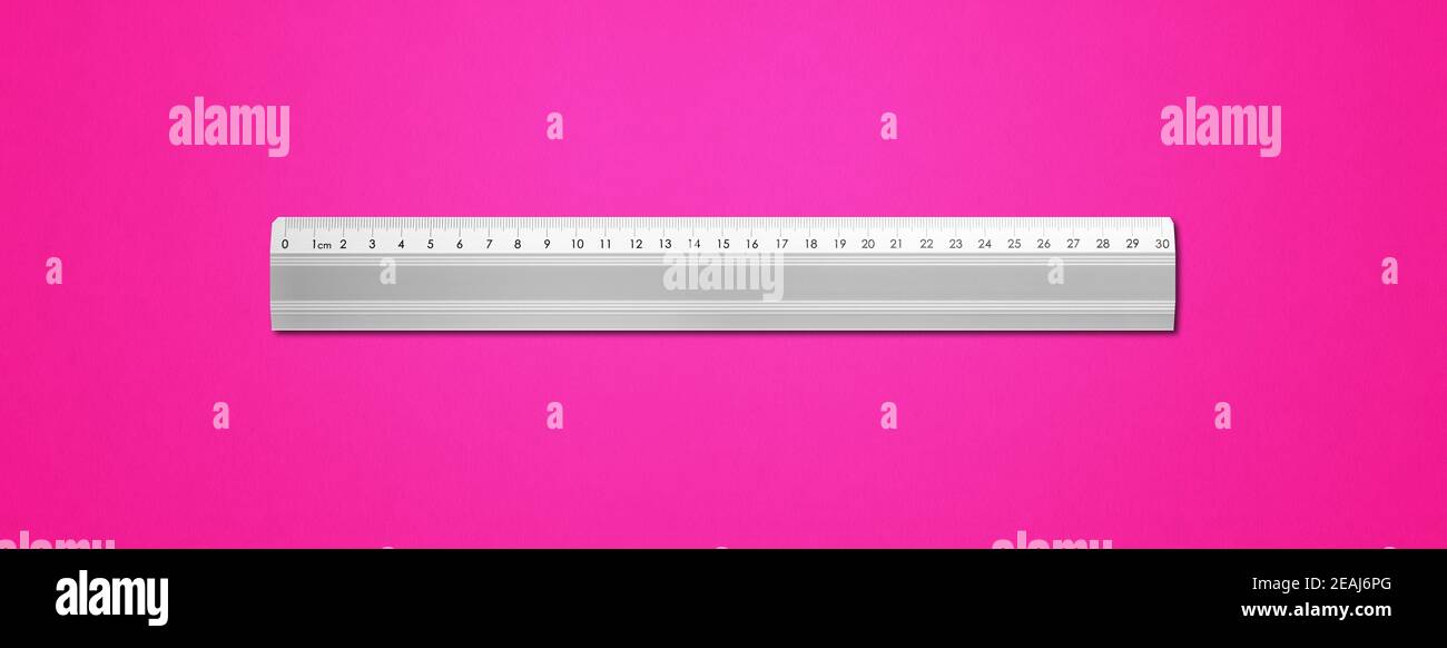 Metal ruler isolated on pink background Stock Photo - Alamy