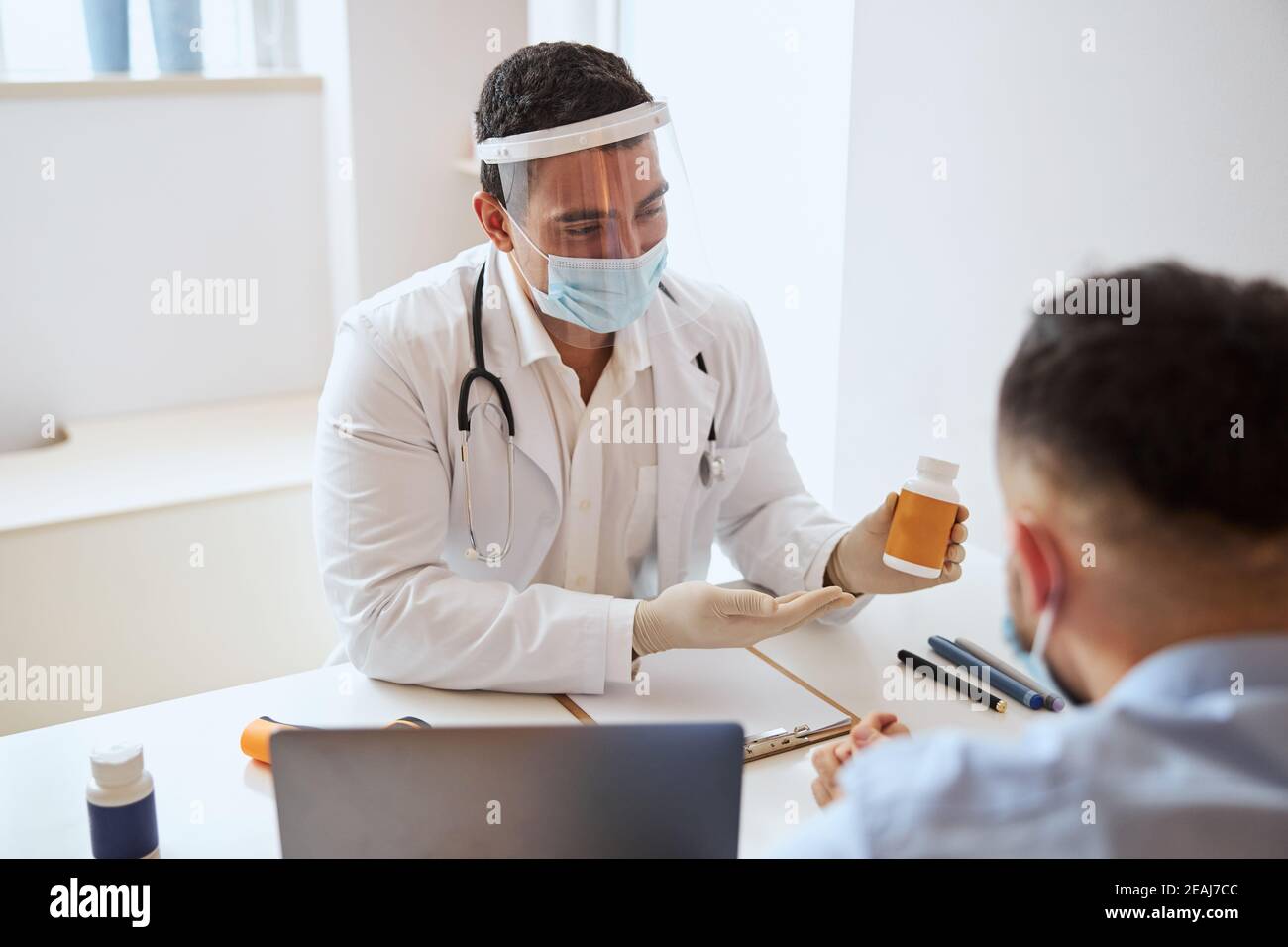 Professional doctor demonstrating medicine drug for patient in room ...