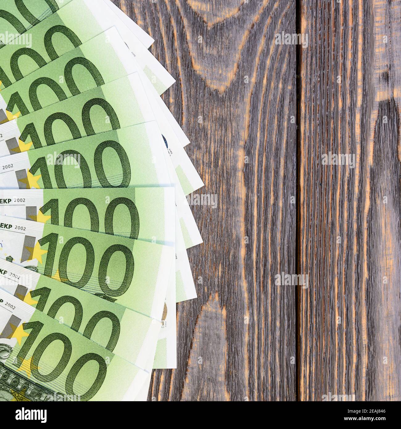 Euro banknotes in fan at wooden background Stock Photo - Alamy