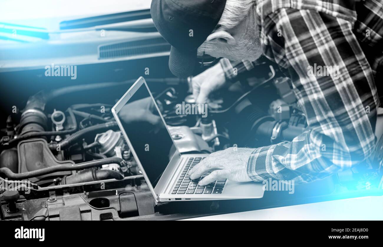Car mechanic using laptop for checking car engine; light effect Stock ...