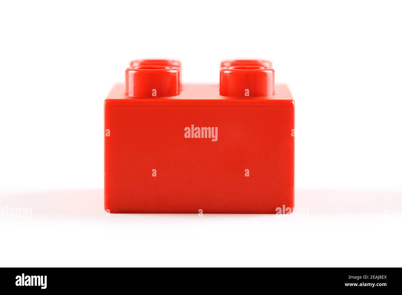 Red plastic lego/duplo block on white background Stock Photo - Alamy