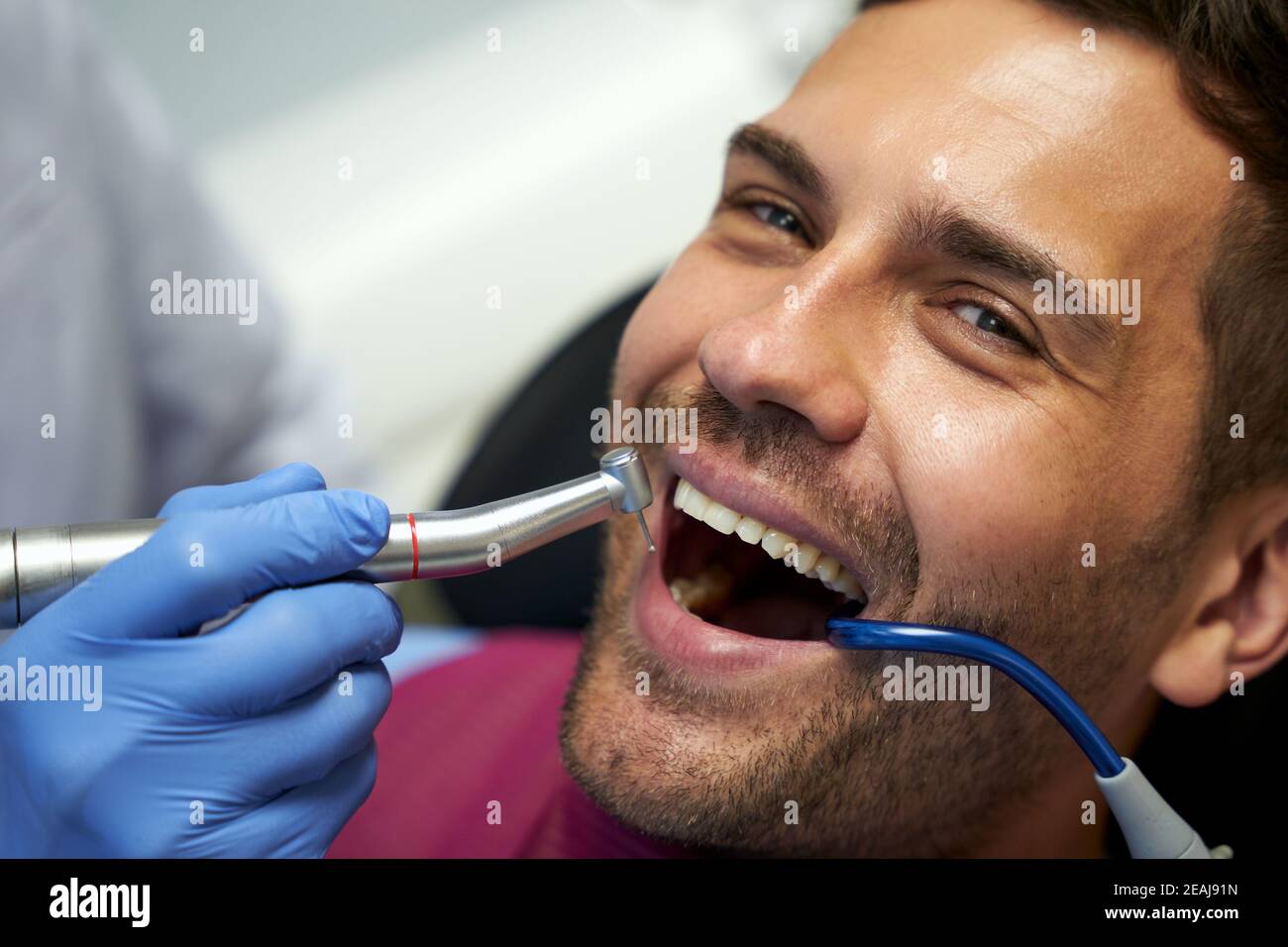 Joyful male patient having dental equipment used in his treatment Stock ...
