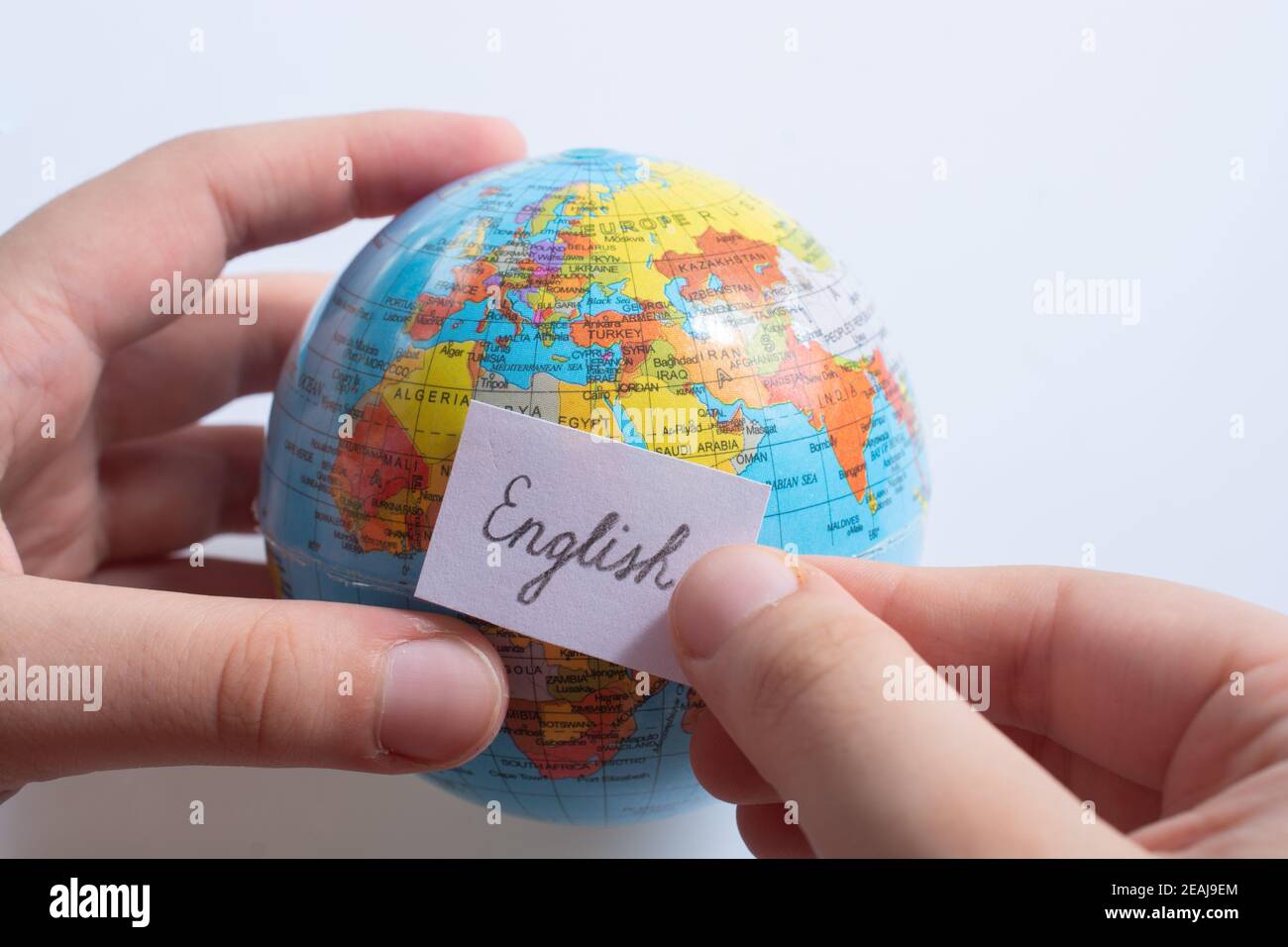Hand holding notepaper with English wording on model globe Stock Photo ...