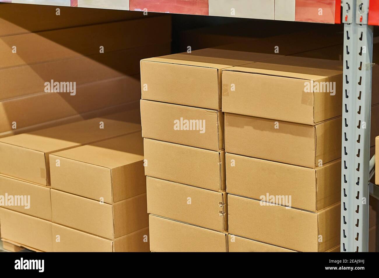Warehouse stocked with boxes in stacks Stock Photo - Alamy