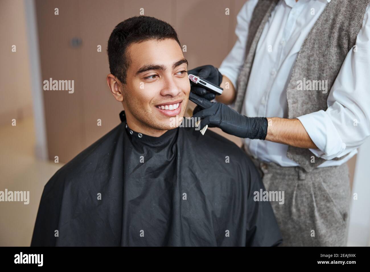 Handsome man relaxing at the beauty procedure in barber shop Stock ...