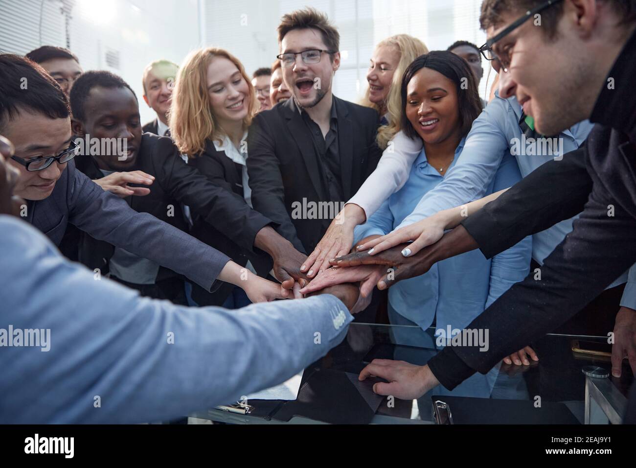 Business team stacking their hands together Stock Photo - Alamy