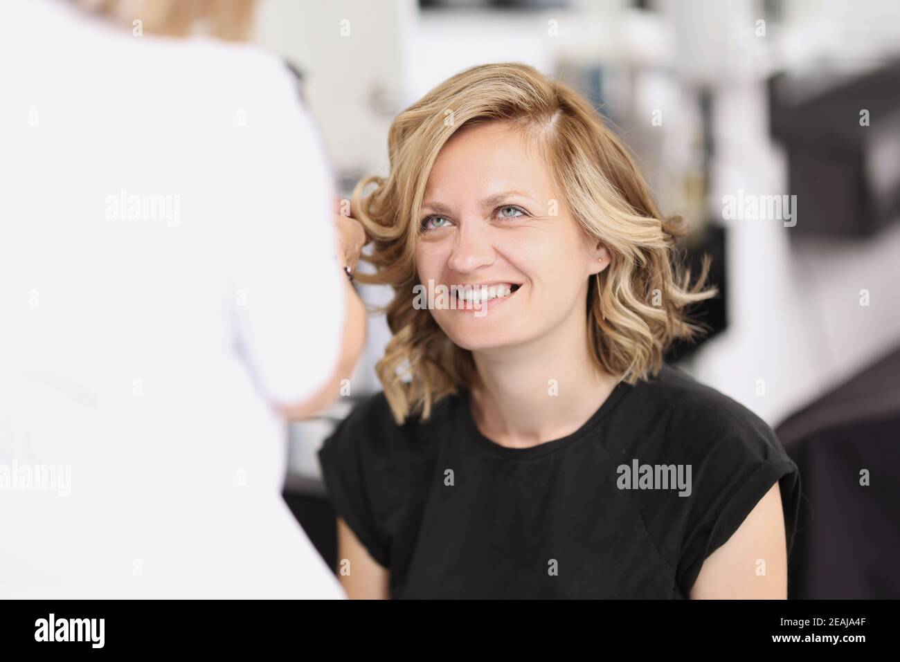 Portrait of smiling woman who has her hair done from curls Stock Photo ...