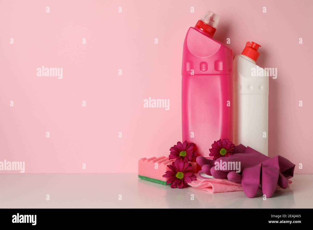 Cleaning tools and flowers on pink background, space for text Stock ...