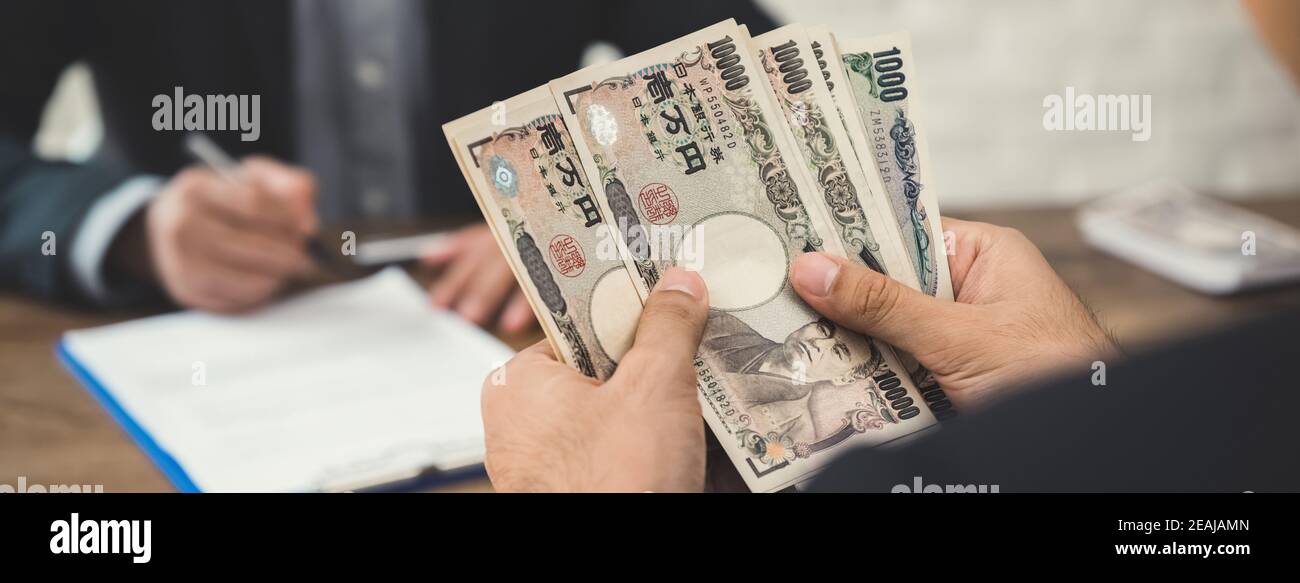 Businessman counting Japanese yen banknotes money after signing loan ...