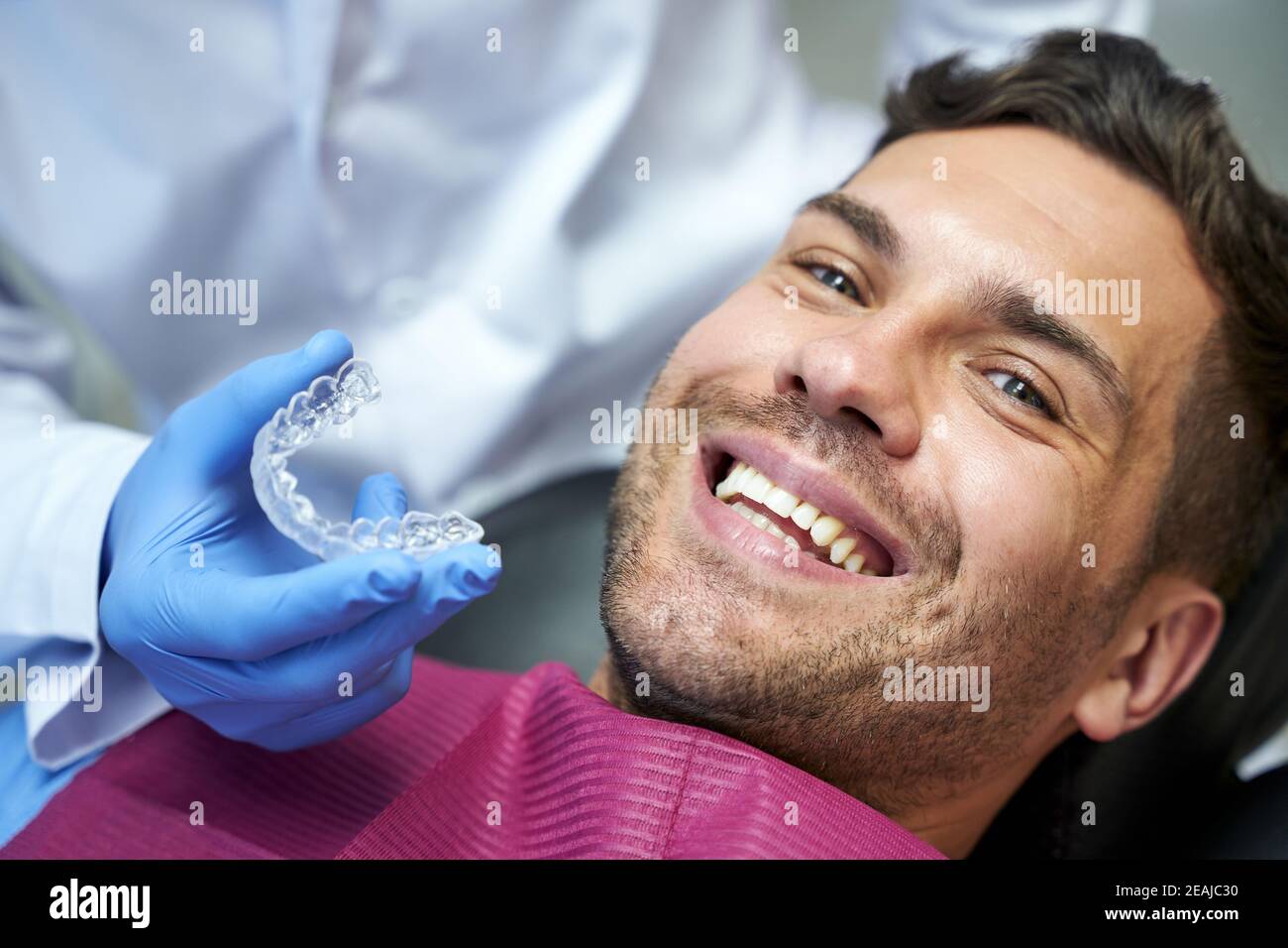 Silicone teeth mold for a young man in dental chair Stock Photo - Alamy