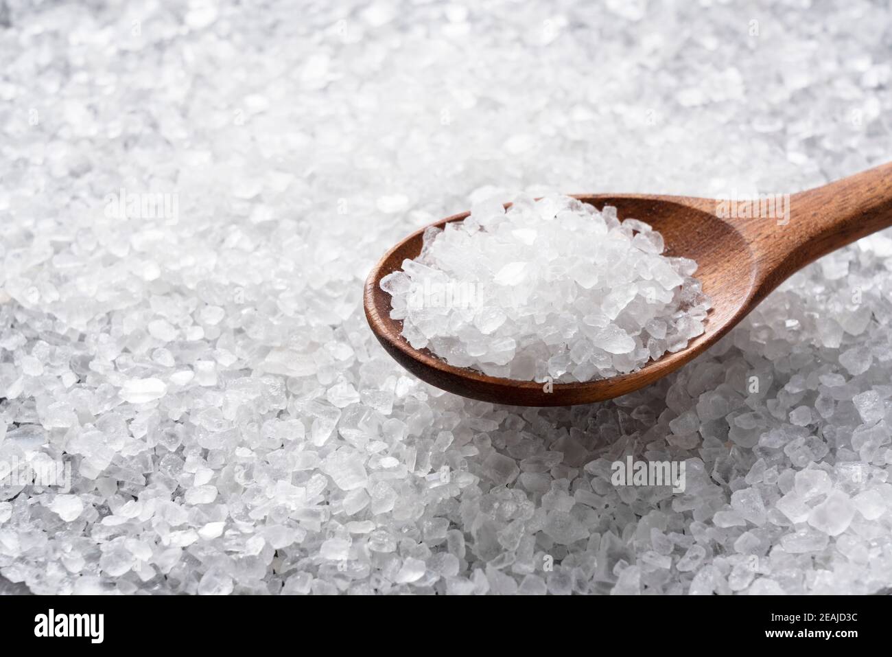 Himalayan rock salt and wooden spoons spread across the screen Stock ...