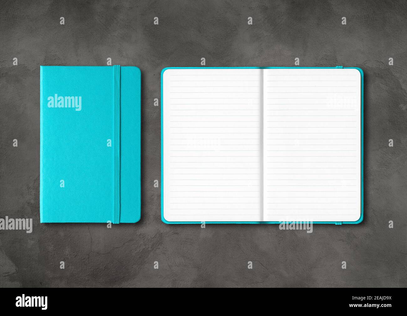 Aqua blue closed and open lined notebooks on dark concrete background ...