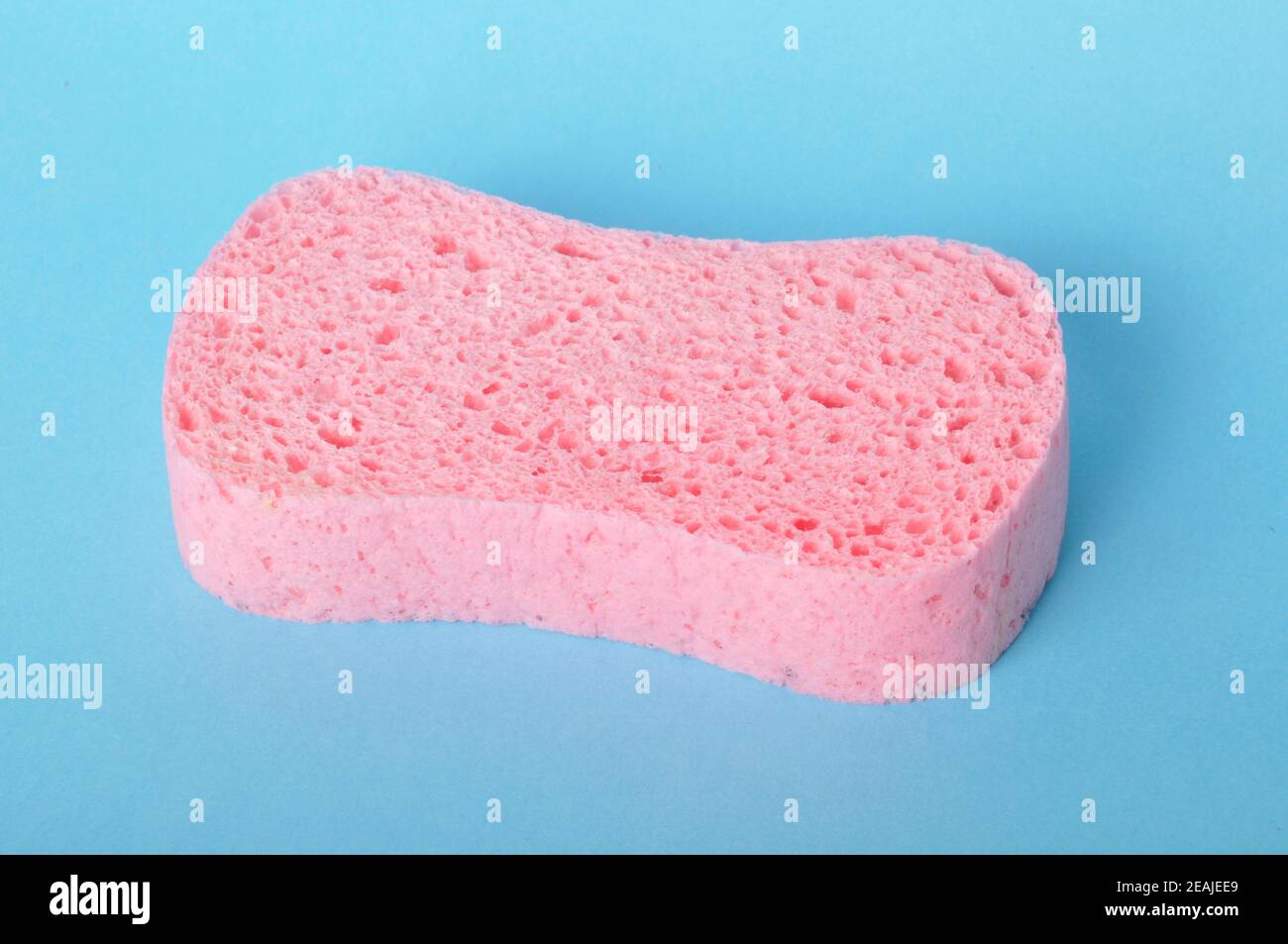 sponge on blue background Stock Photo - Alamy