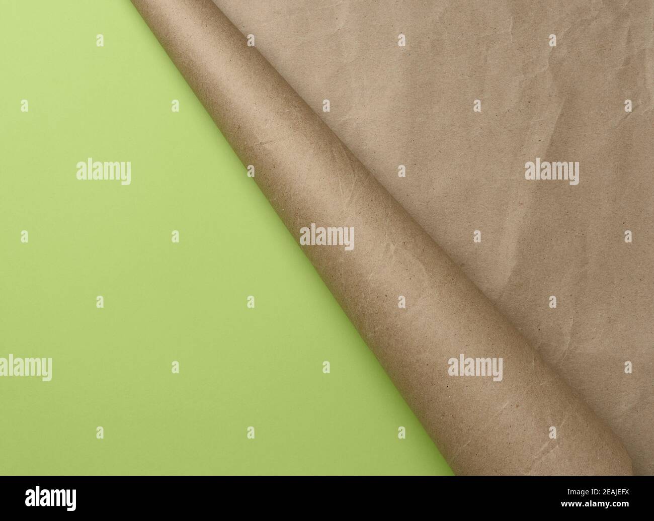 folded corner of a roll of brown paper on a green background Stock ...