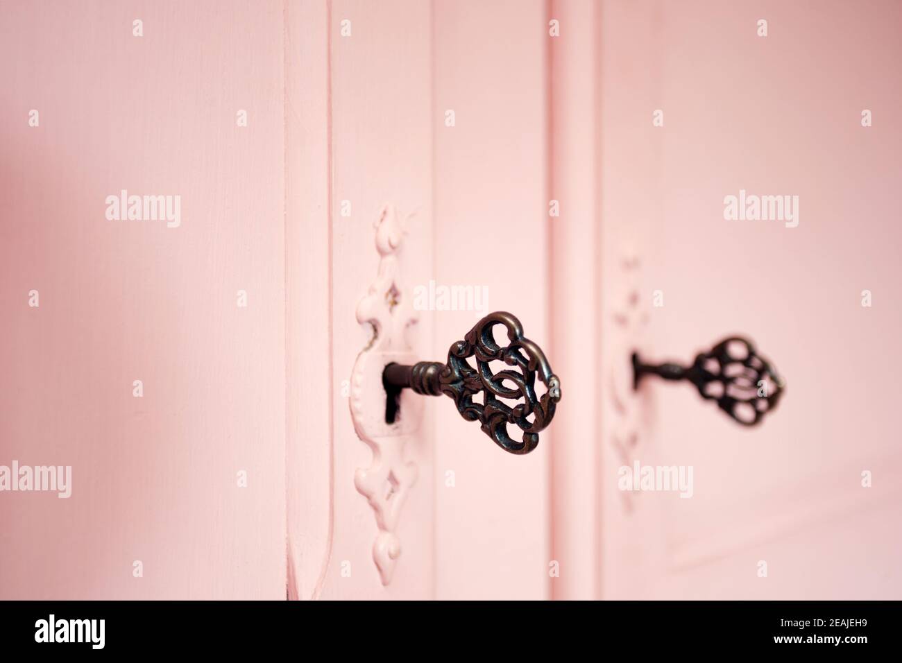 Pink vintage antique doors with old skeleton keys in lock wooden ...