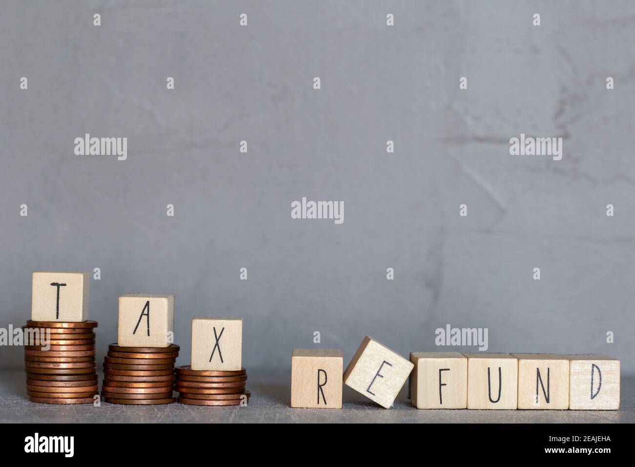 Tax refund text with wooden cubes on concrete modern background texture ...
