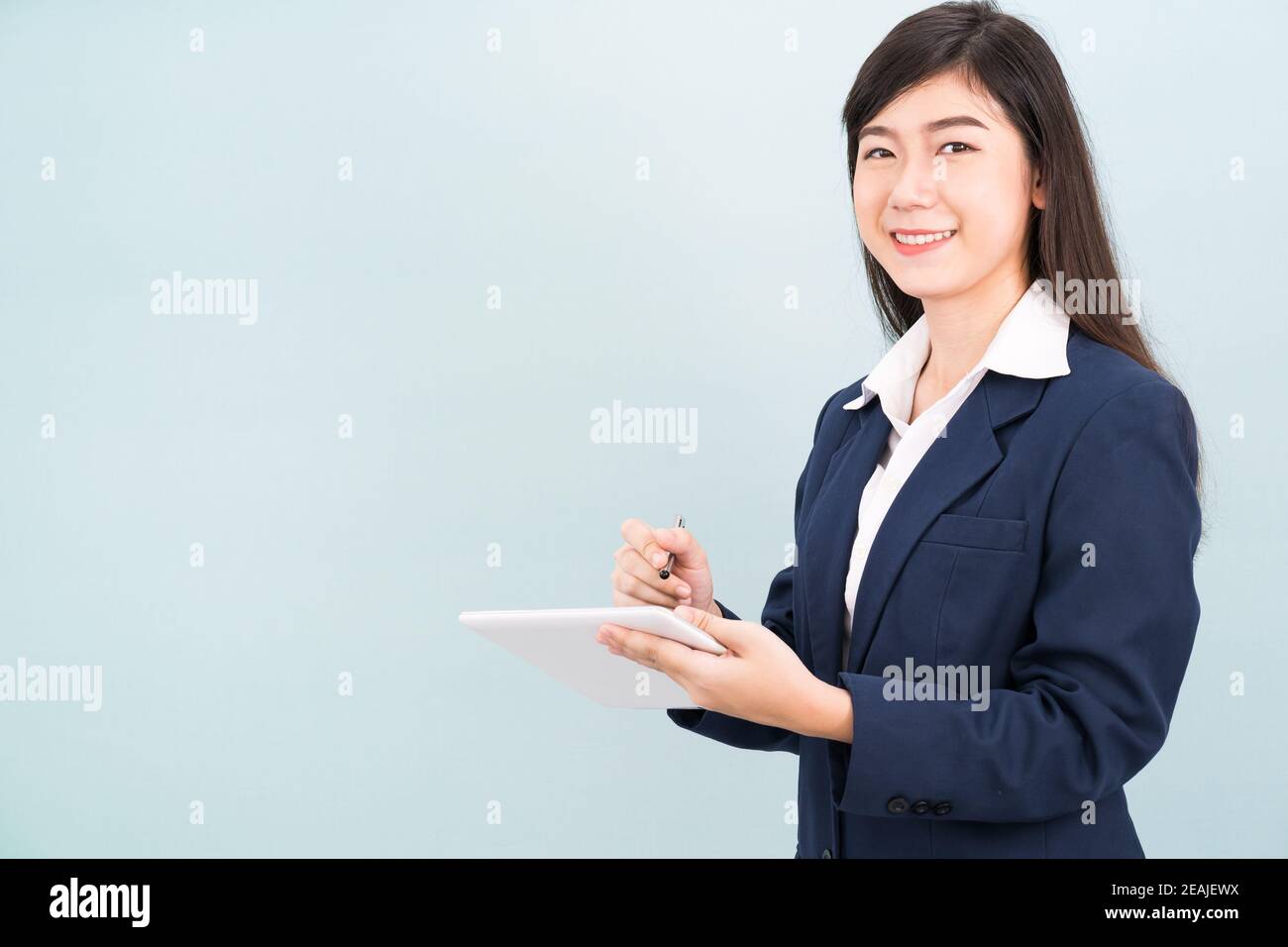 Teenage girl in suit using computer digital tablet Stock Photo - Alamy