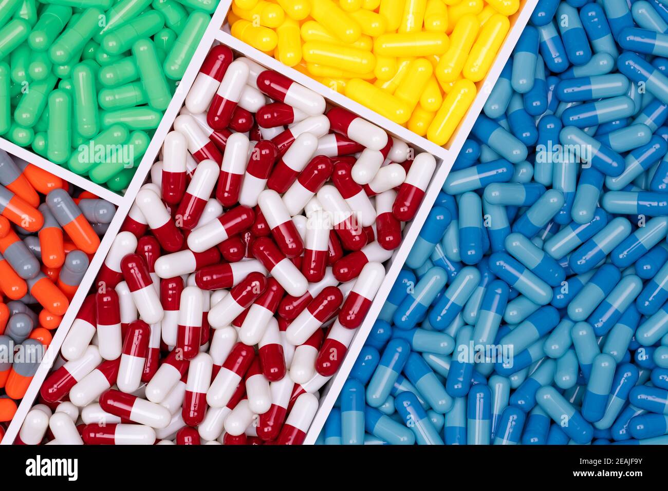Top view of colorful capsule pills in plastic tray. Pharmaceutical ...