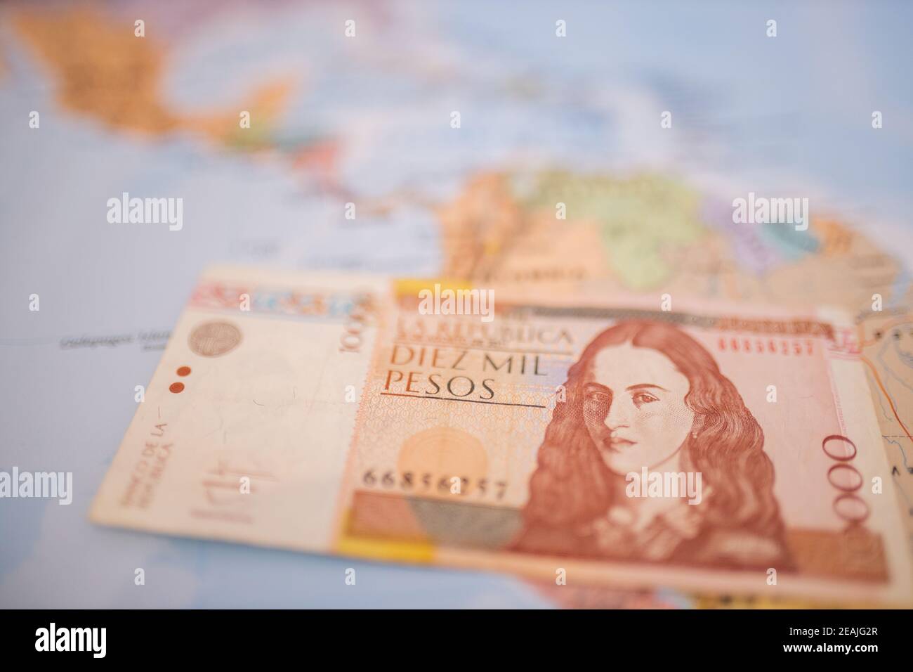 Ten thousand Colombian pesos bill below Colombia on a colorful and ...