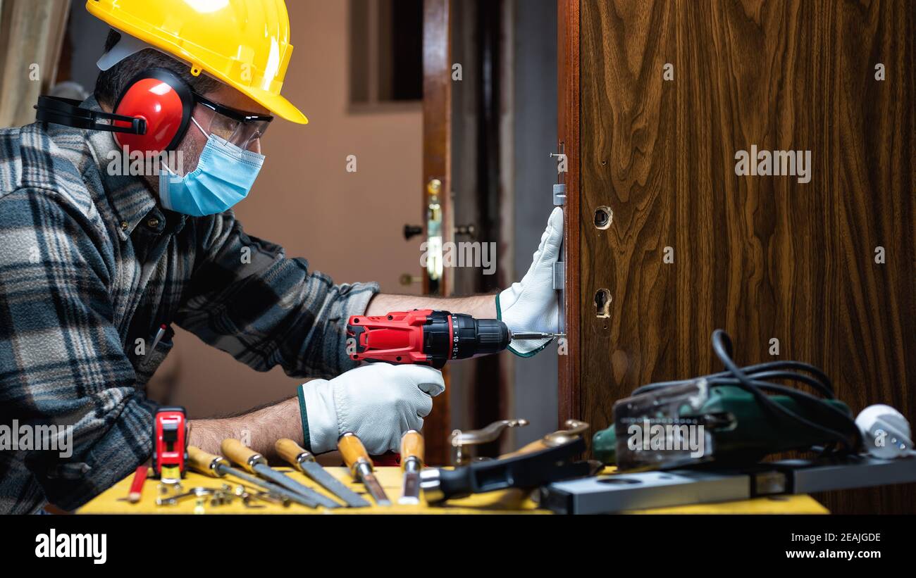Carpenter at work protects the face with the surgical mask. Covid-19 ...
