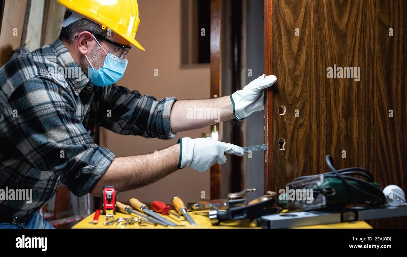 Carpenter at work protects the face with the surgical mask. Covid-19 ...