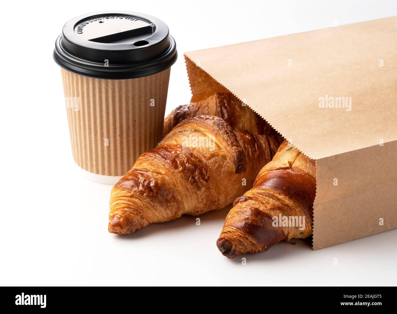 A croissant protruding from a paper bag on a white background and ...