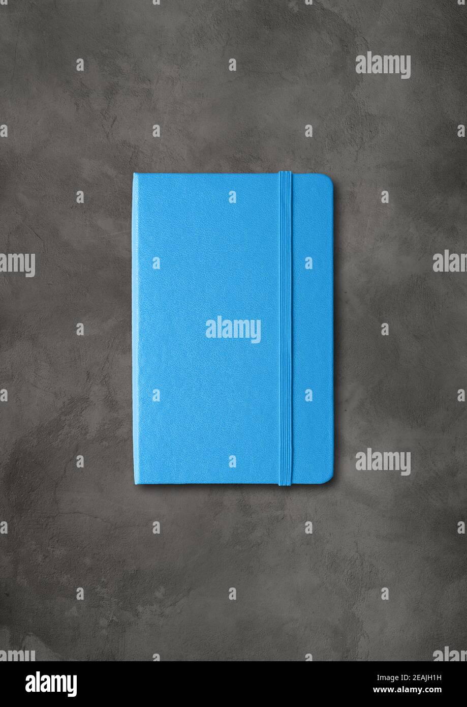 Blue closed notebook on dark concrete background Stock Photo - Alamy