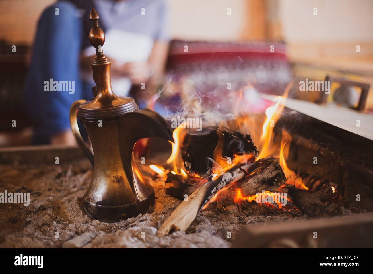 Traditional arabic coffee pot named dallah in fireplace inside the tent ...