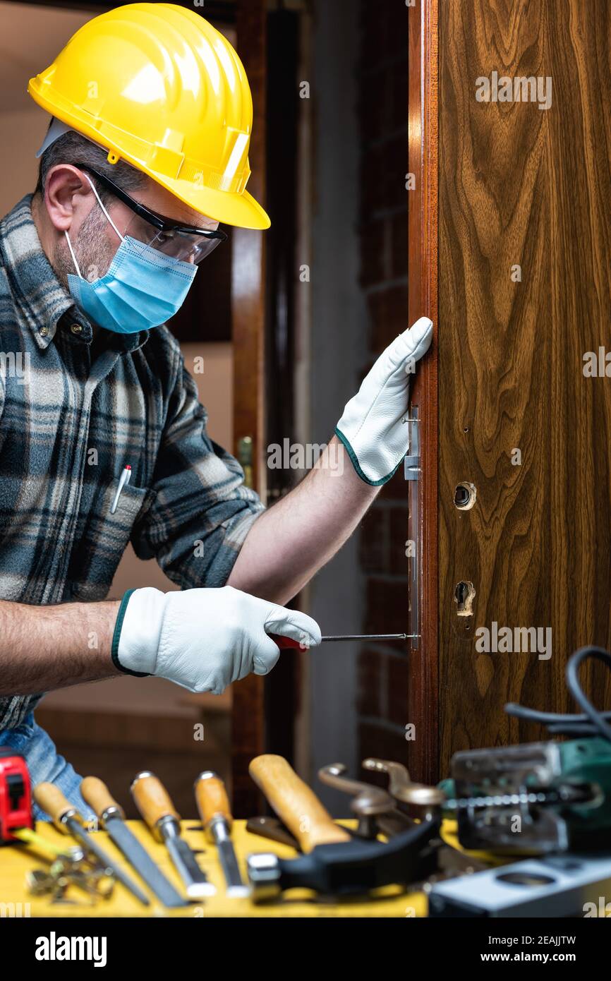 Carpenter at work protects the face with the surgical mask. Covid-19 ...